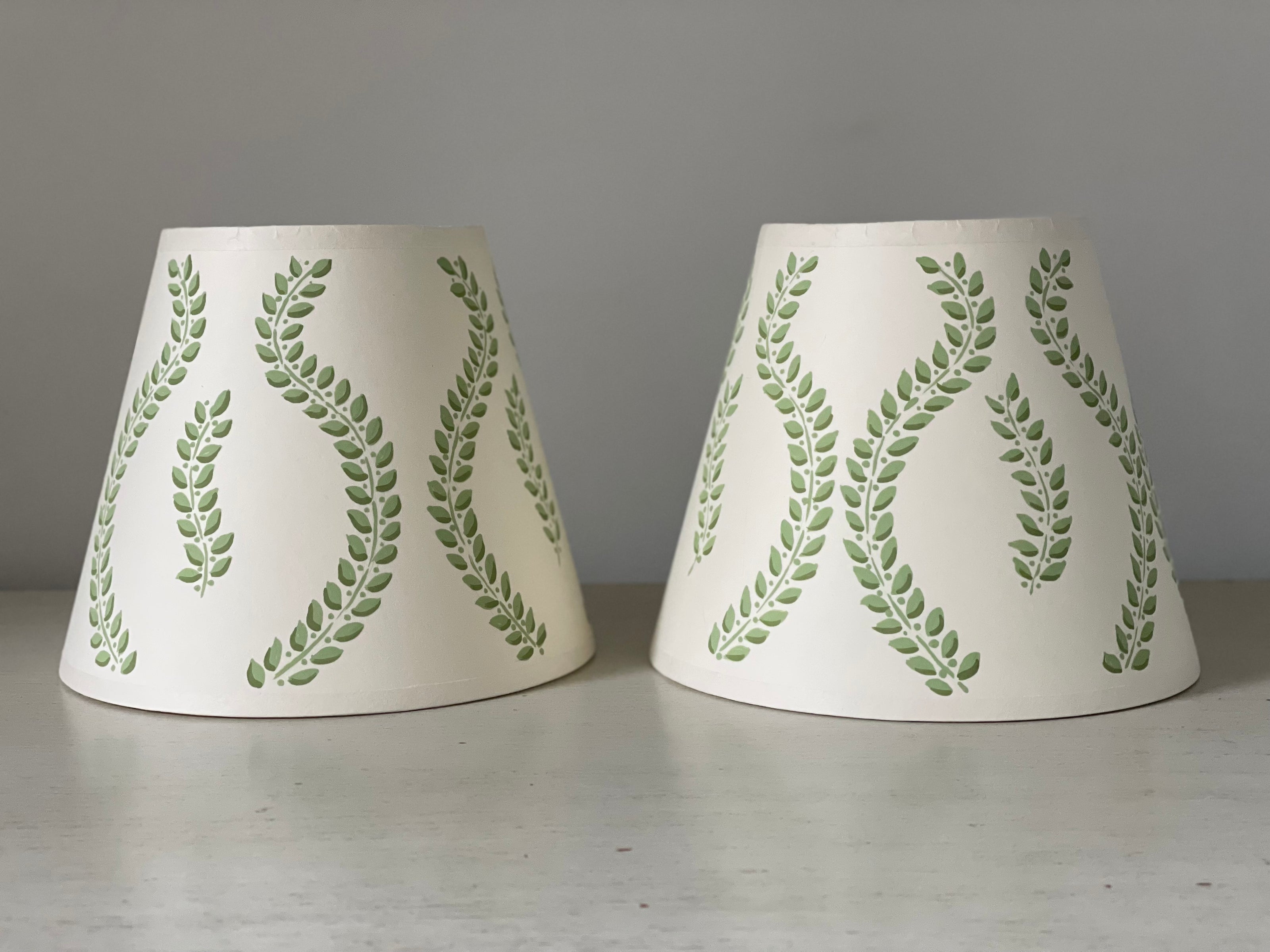Handpainted lampshades with decorative leaf design in a bespoke green paint